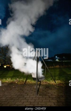 Smoke rising from a hanging fire pit Stock Photo - Alamy