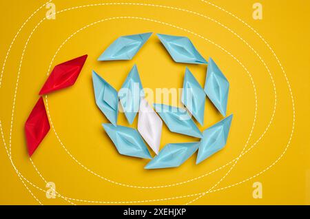 A group of colorful paper boats clustered on a yellow background Stock ...
