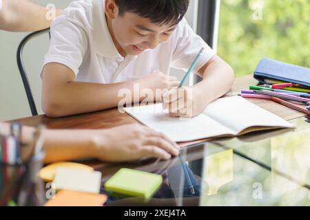 Asian father helps son to do her homework for the school. child study ...