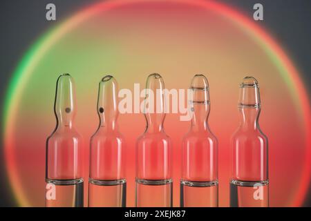 Ampoules for injection against the background of a bright orange circle ...