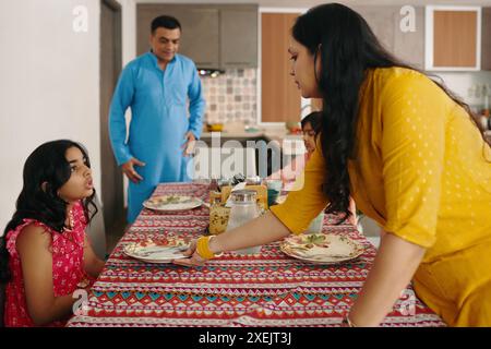 Serving for dinner on kitchen table. Warm kitchen background interior ...