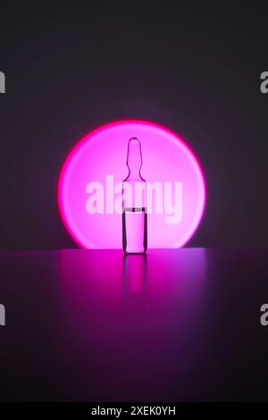 Several ampoules for injection with medicines on a blue background ...