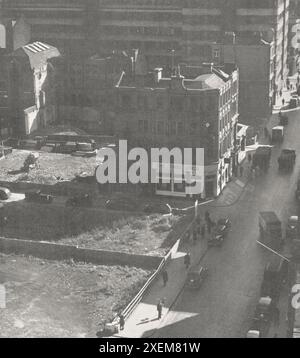 City of London Blitz bomb damage. A ground level view with the spire of ...