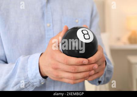 Eight ball symbol for success closeup on eightball with light ...