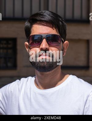 Close-up portrait of a modern Pakistani man with a dark beard, light ...