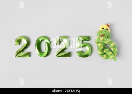 Knitted toy striped green snake and green numbers. The symbol of the ...