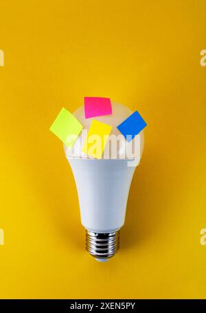 Light bulb covered with papers of different colors that express a wide ...