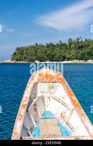 Patokan Beach (Jiko) with a boat on the white sand beach and palm trees ...
