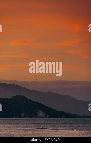 Sunset over Patokan Beach (Jiko) and silhouetted hillsides in North ...