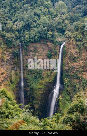Waterfalls at Tad Gneuang Waterfall, dropping from a high cliff with ...