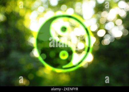 Yin and yang symbol against blurred view of green park Stock Photo - Alamy