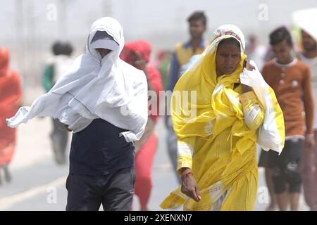 Indian people walk around the banks of river Ganges during the Heat ...