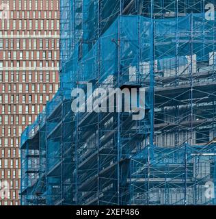mesh-covered scaffolding during building restoration work Stock Photo ...