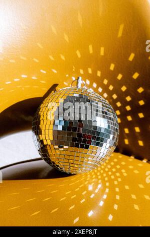 Disco Ball on yellow chair Stock Photo - Alamy