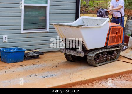 Construction workers use dumper tracked wheelbarrow when pouring ...