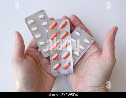 Human hands holding medical capsules packed in blister. Caucasian ...