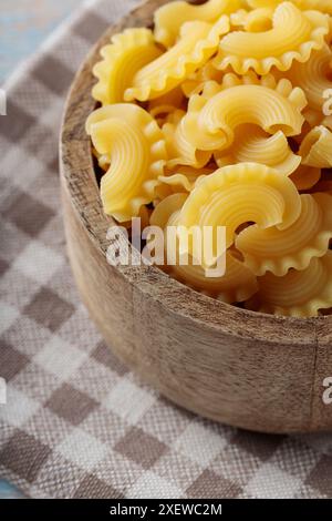 Pasta creste di gallo in a wooden olive spoon flatlay isolated on white ...