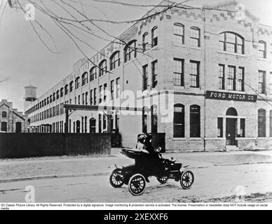 Workers on the first moving assembly line put together magnetos and ...