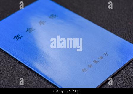 Pension book or Japanese citizen ID card on dark concrete background ...