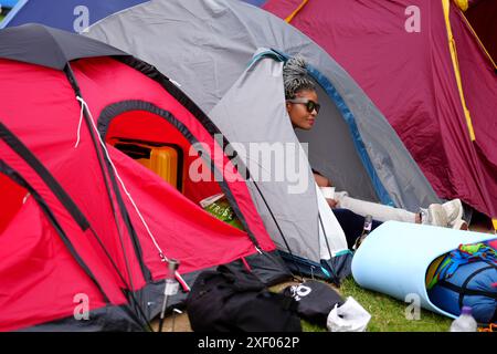 A spectator in the overnight queue ahead of the Wimbledon Championships ...