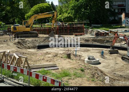 Street under repair with dug holes and construction equipment Stock ...