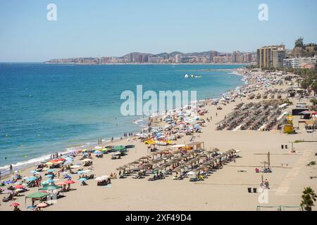 Busy beach in summer at Fuengirola, on a clouded day, during pandemic ...