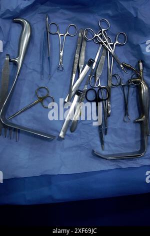Closeup view of stainless surgical needle drivers lying down on steel ...