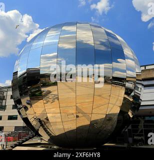 The Millennium Sphere reflecting blue sky and fluffy clouds in ...