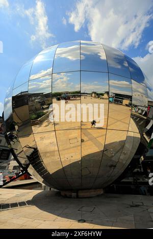 The Millennium Sphere reflecting blue sky and fluffy clouds in ...