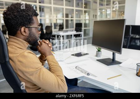 Skillful man architect creating blueprints for new projects on computer ...