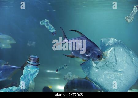 Fishes swimming among plastic garbage in sea. Environmental pollution ...