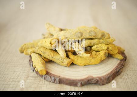 A detailed image captures turmeric roots drying in sunlight, part of ...
