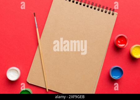 Album pages and paints, pencils, brush on a colored background. Top ...