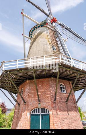 old wooden windmill under blue sky Stock Photo - Alamy