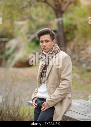 Young man wearing winter clothes walking in the street Stock Photo - Alamy