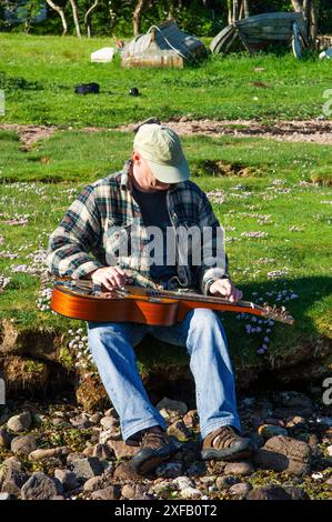 Robin Clark owner of Busker Guitars plays one of Busker guitars ...