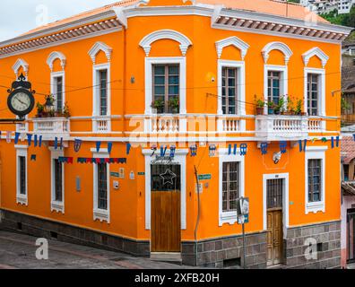 Colourful orange colonial style building on narrow street, Quito Old ...
