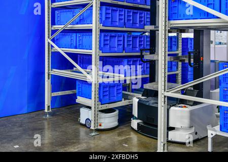 Autonomous Robot transportation in warehouses automation. Robots in storage hangar. AGV for ...