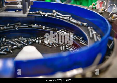 Many small Screw nuts by manufacturing process in factory Stock Photo ...