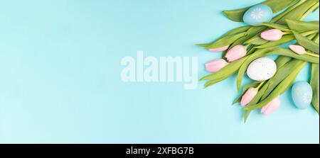 Nest with small eggs and pink tulips on a purple colored background ...