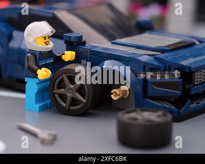 Tambov, Russian Federation - July 01, 2024 Lego driver changing wheel ...