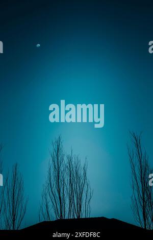 Dramatic evening blue sky with moon Stock Photo - Alamy