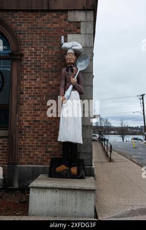Statue of a chef carrying a spoon at Isaac's Way restaurant on Queen ...