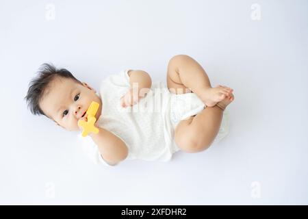 a baby laying on the floor with a paco Stock Photo - Alamy
