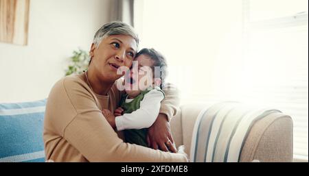 Home, granny and hug for crying baby, sad and comfort in living room ...