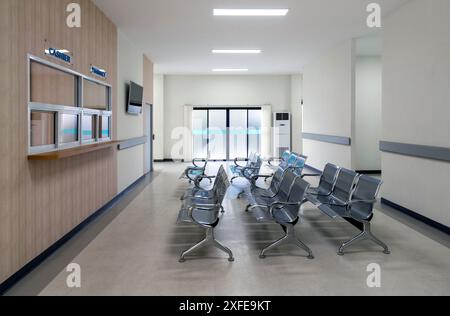 An empty waiting area with chairs, a cashier sign, and a pharmacy ...
