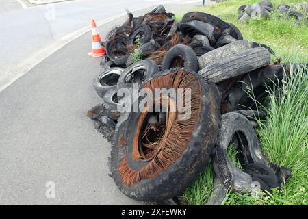 burnt car tyres after a roadside blockade by farmers, France, Brittany ...