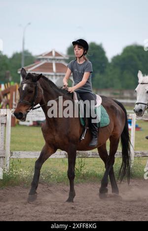 Teenage girl learning to gallop on horseback Stock Photo - Alamy