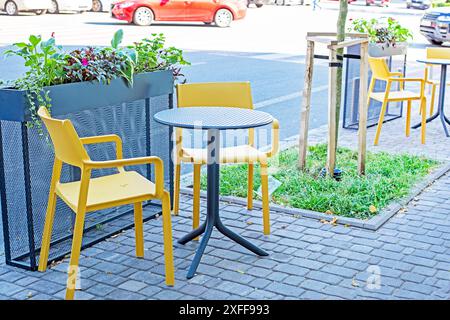 street cafe with wicker furniture and fresh red flowers. Daily ...