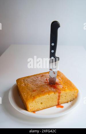 Cake stabbed by a kitchen knife Stock Photo - Alamy